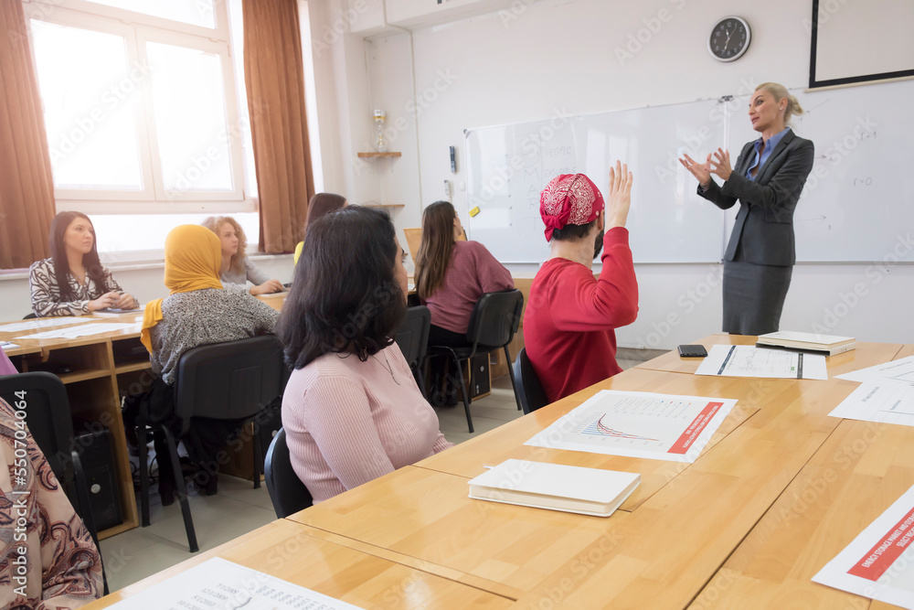 Female teacher or professor giving a lecture in a classroom Stock Photo ...