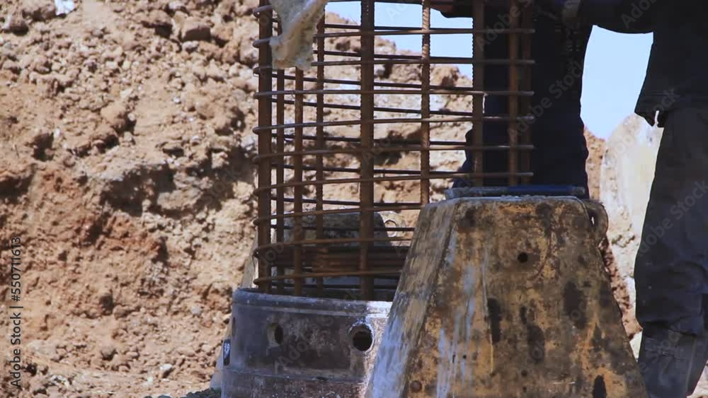 Crane installation of framing rebar at construction site for concrete ...