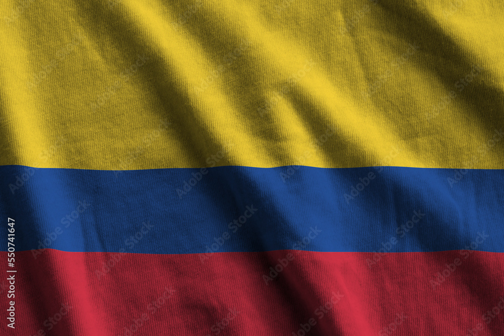 Colombia flag with big folds waving close up under the studio light ...