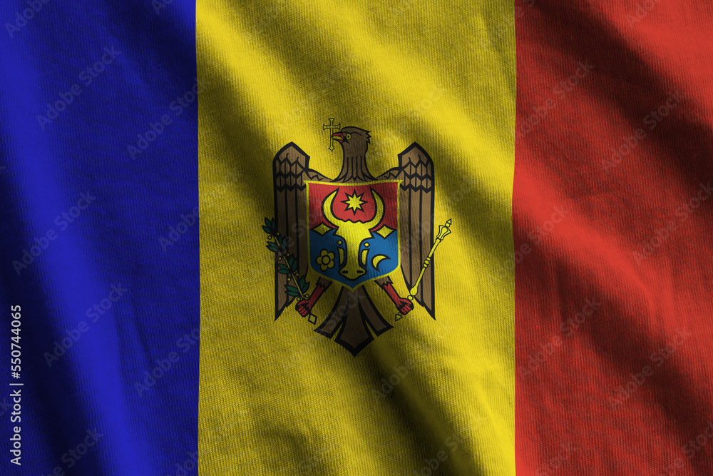 Moldova flag with big folds waving close up under the studio light ...