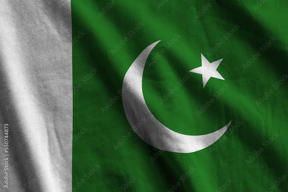 Pakistan flag with big folds waving close up under the studio light ...