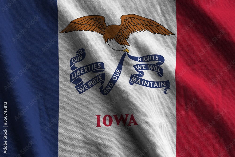 Iowa US state flag with big folds waving close up under the studio ...