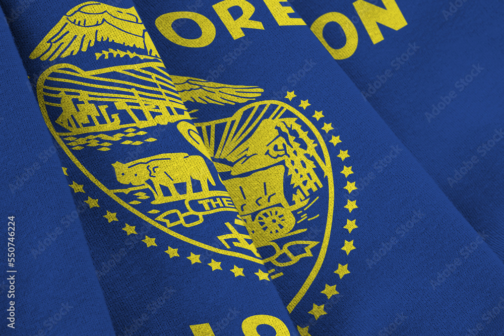 Oregon US state flag with big folds waving close up under the studio ...