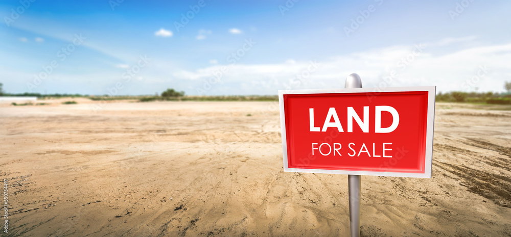land for sale sign against trimmed lawn background. Empty dry cracked ...