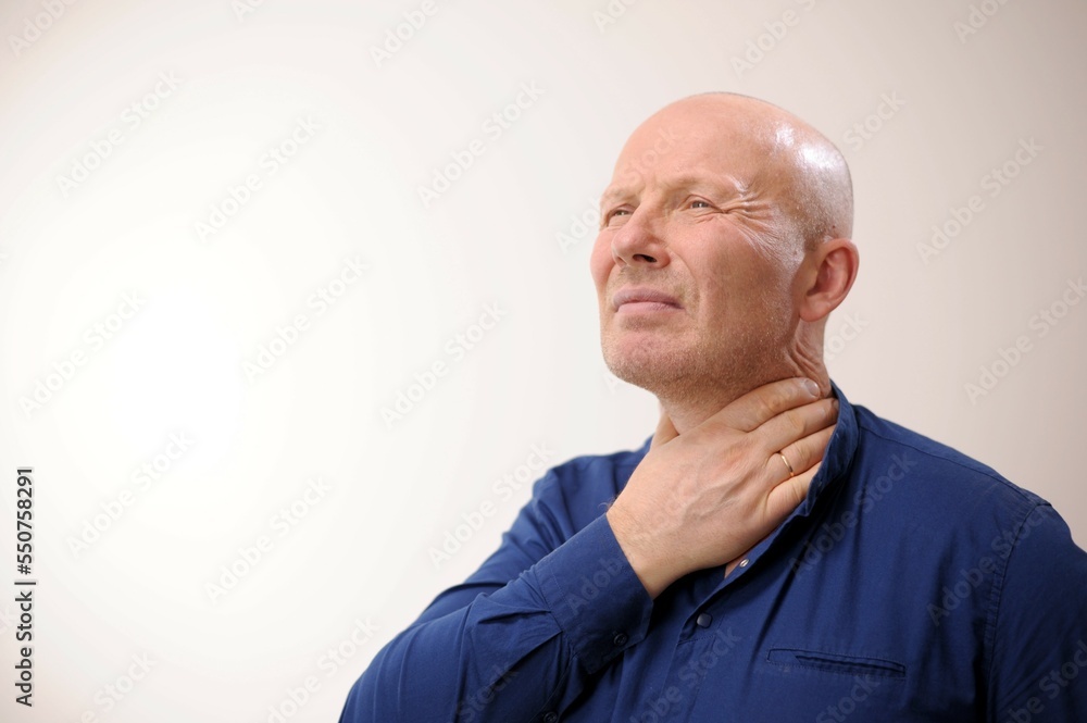 Emotions of an adult handsome bald man Sore throat man holding his hand ...