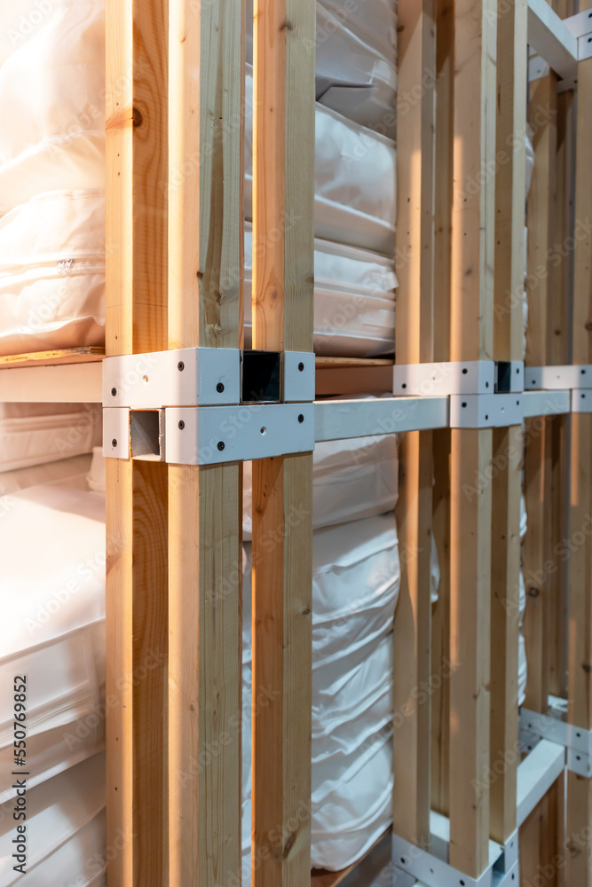 Steel holds a square timber structure in place. Stock Photo | Adobe Stock