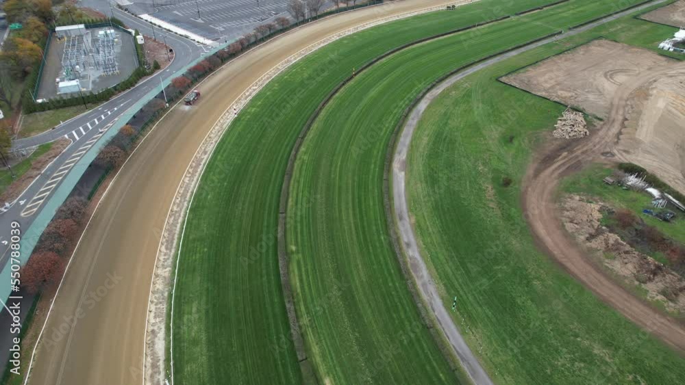 An aerial view of a horse race track on a cloudy day, while it was ...