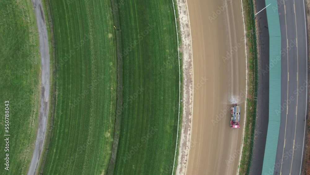 An aerial view of a horse race track on a cloudy day, while it was ...
