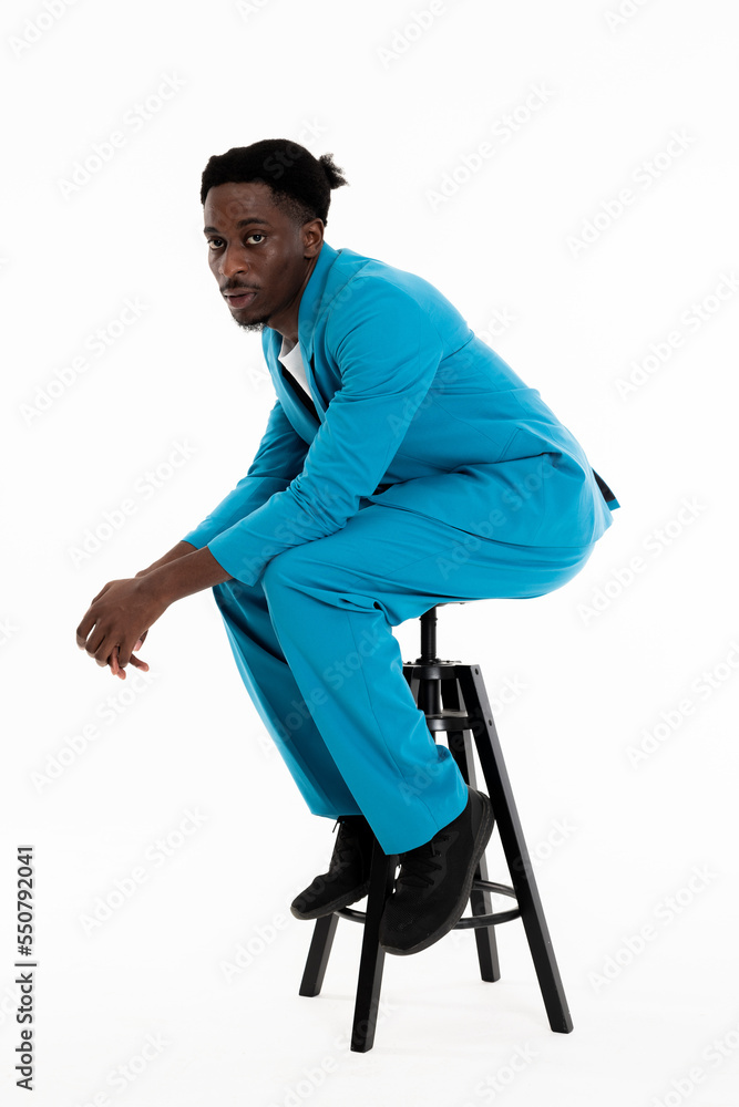 Side of the view young african american man model sitting on black ...