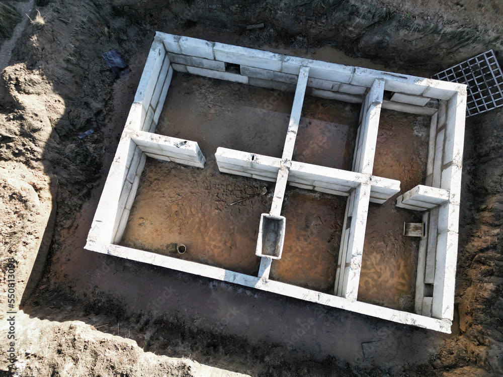 Construction of the foundation of the building from concrete blocks ...