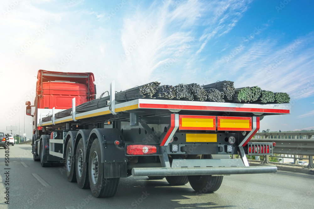 Truck with a long trailer loaded with metal rebar frame for the ...