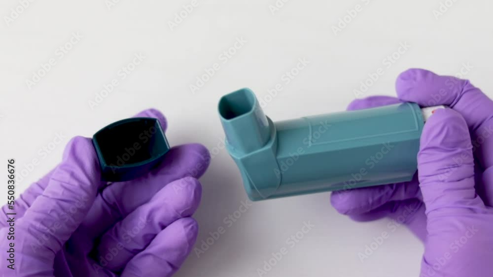 doctor medical assistant hands in purple surgical gloves putting on ...