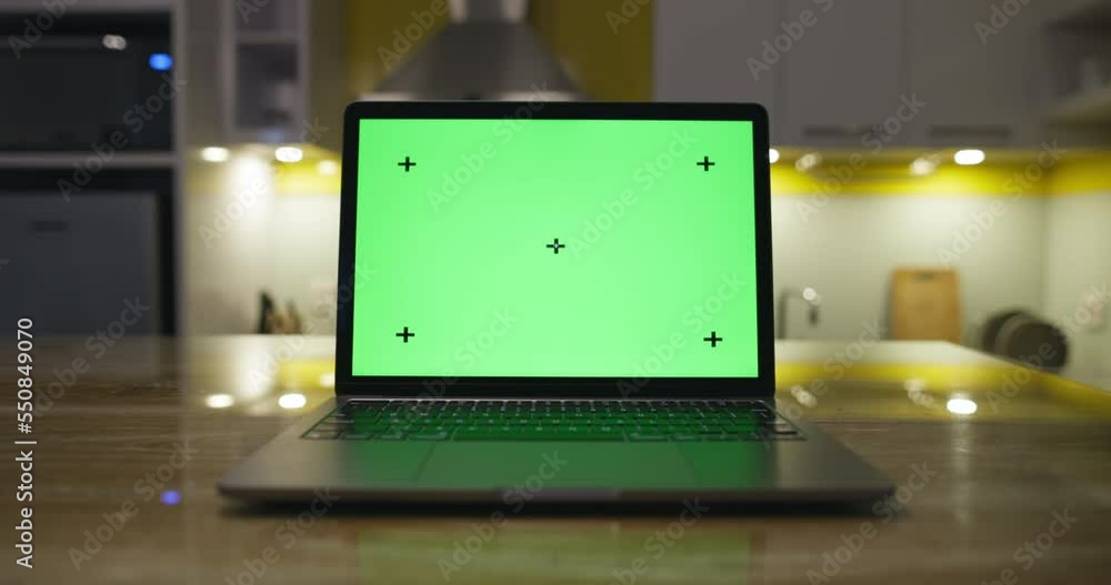 Close up shot of modern kitchen chroma key green screen laptop computer ...