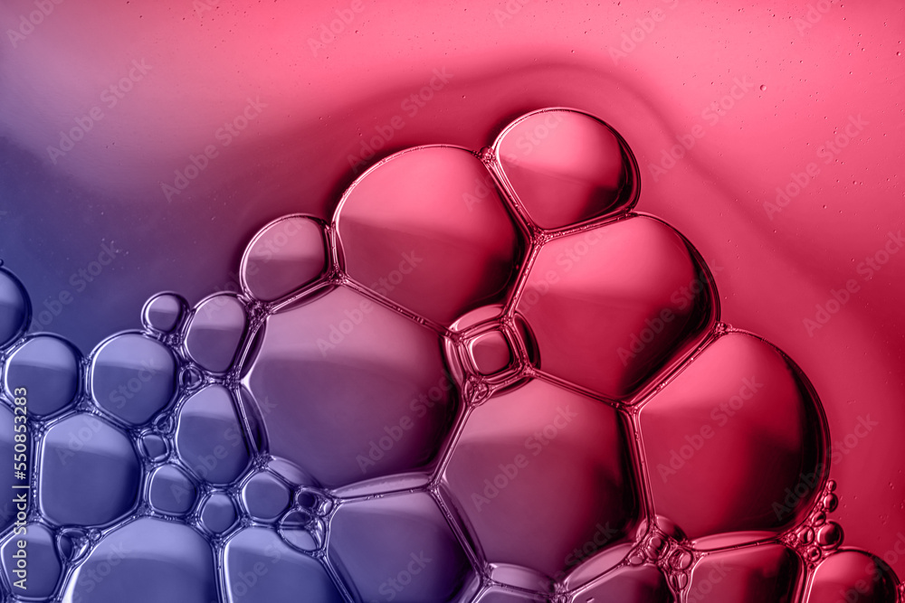 Magenta and purple liquid background with bubbles. Top view. Change ...