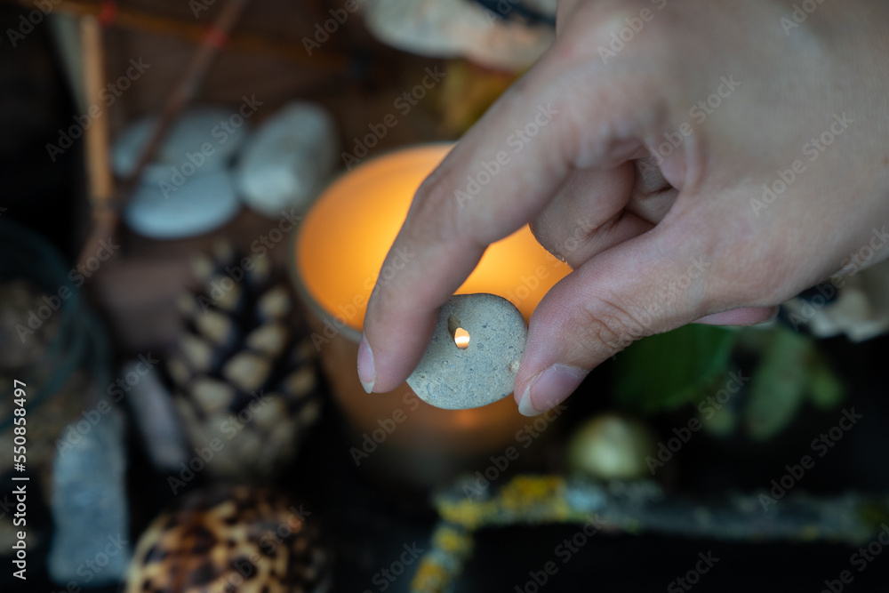 Witch hand holds adder stone. Magic items scene. Witchcraft objects ...