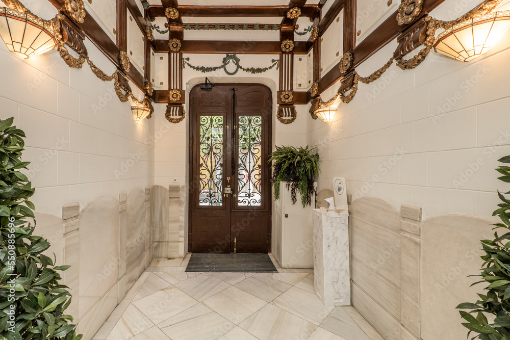 Interior of a portal of an old house with white marble floors and a ...