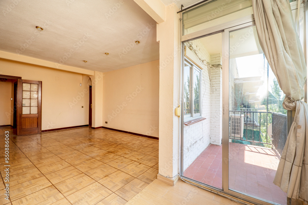 Living room of a house with access to a terrace with terracotta floors ...