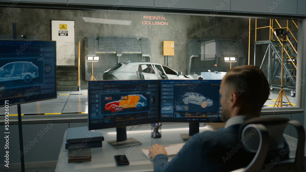 An engineer in a crash test lab uses a car crash test system to ...