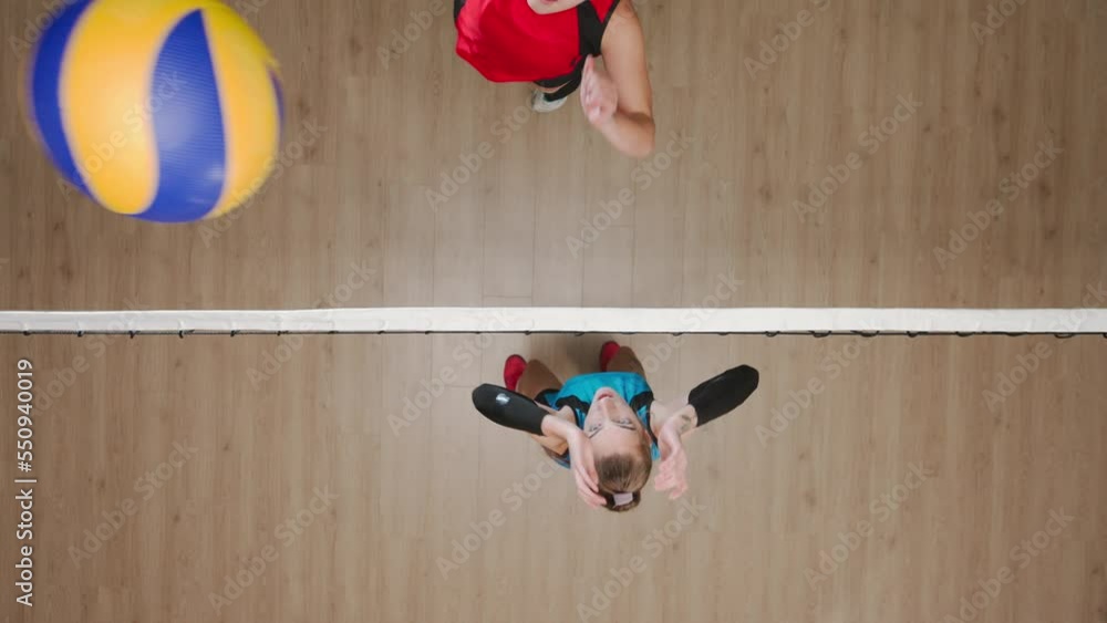 Two young female athletes playing volleyball on playground. Top view of ...