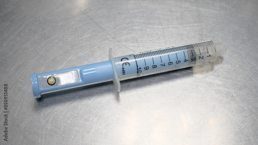 On the table lies a syringe manometer to measure the pressure and ...