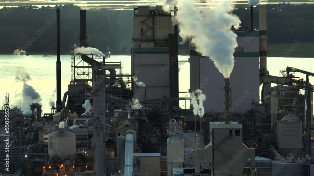 Huge factory with high chimneys polluting atmosphere with carbon ...