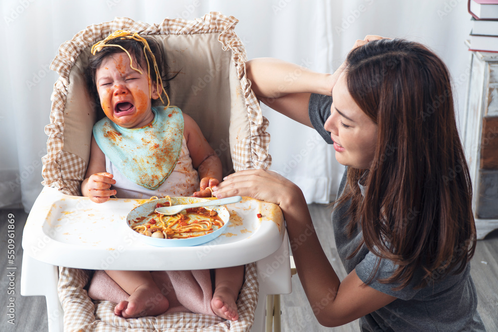 Stockfoto Unhappy mixed race toddler child messy tomato sauce on face ...