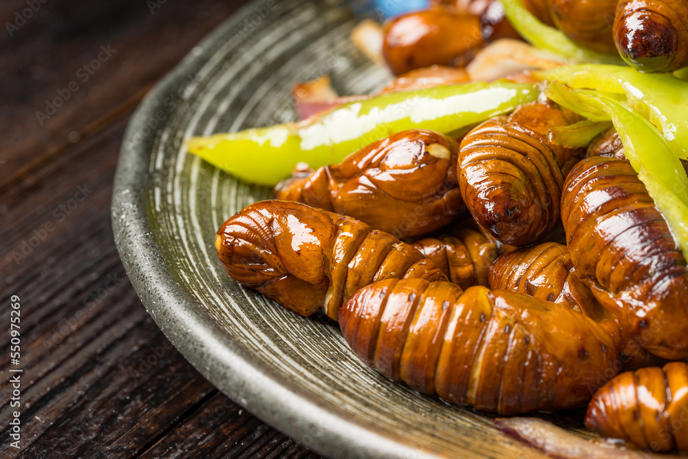 Stir-fried cocoon pupae is a special food in northeast China 스톡 사진 ...