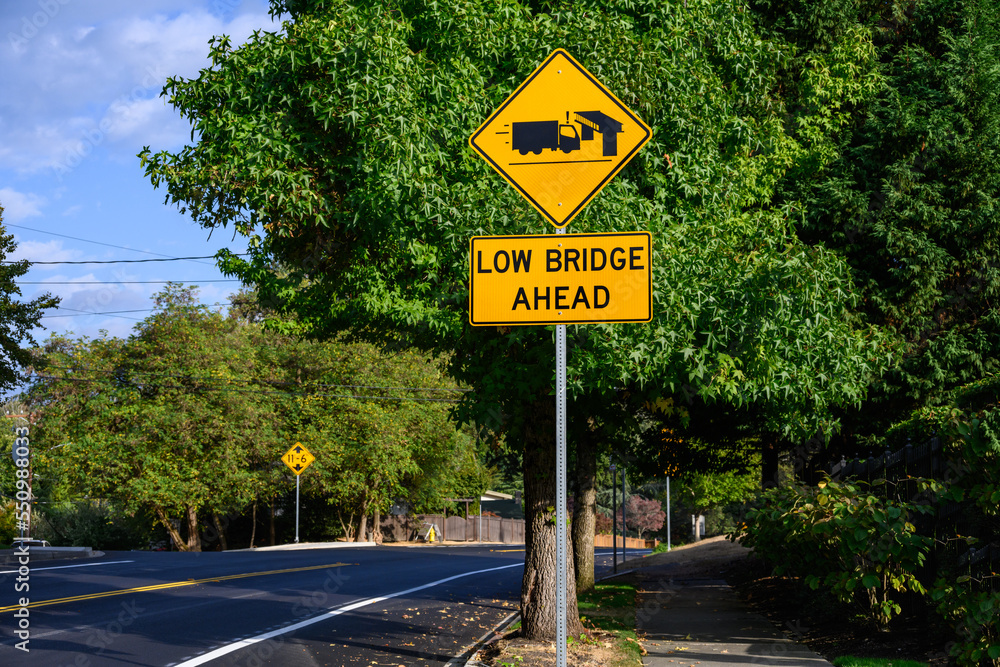 Yellow road sign, Low Bridge Ahead with a truck and bridge symbol ...