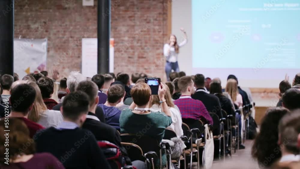 Speaker at conference make a poll from the scene. Business and ...