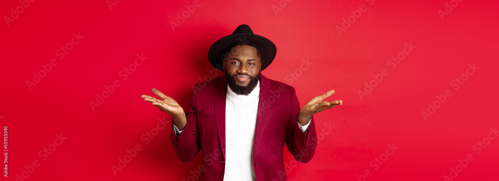 Clueless and unbothered Black man shrugging with indifferent look, dont ...