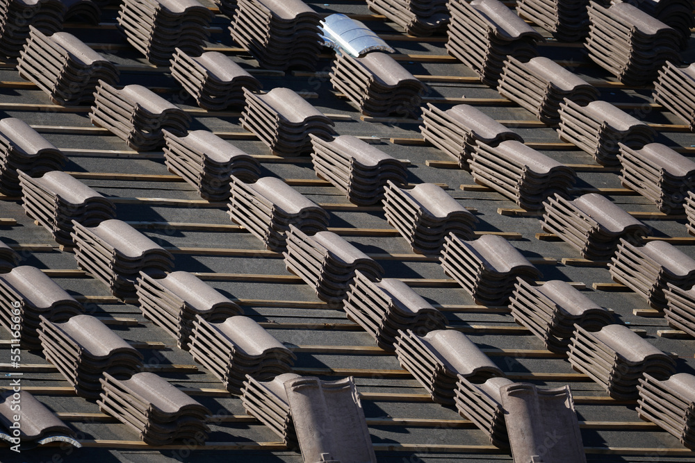 New roof tiles stacked on roof ready for laying on a house Stock Photo ...