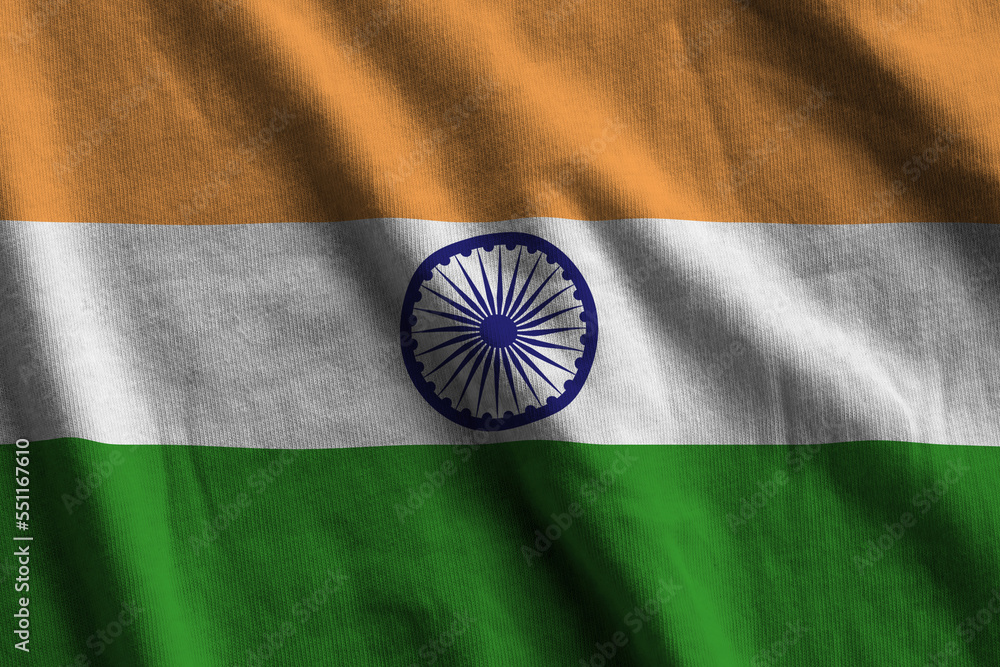 India flag with big folds waving close up under the studio light ...