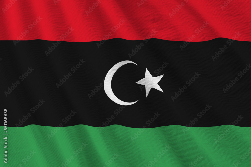 Libya flag with big folds waving close up under the studio light ...
