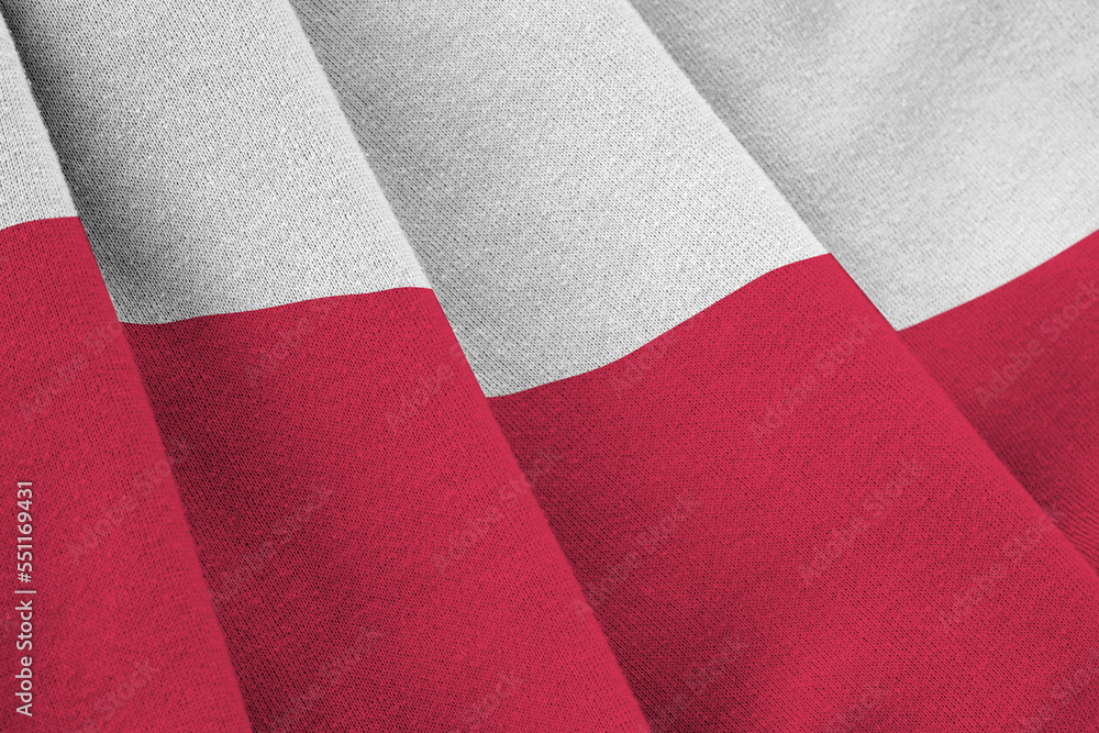 Poland flag with big folds waving close up under the studio light ...