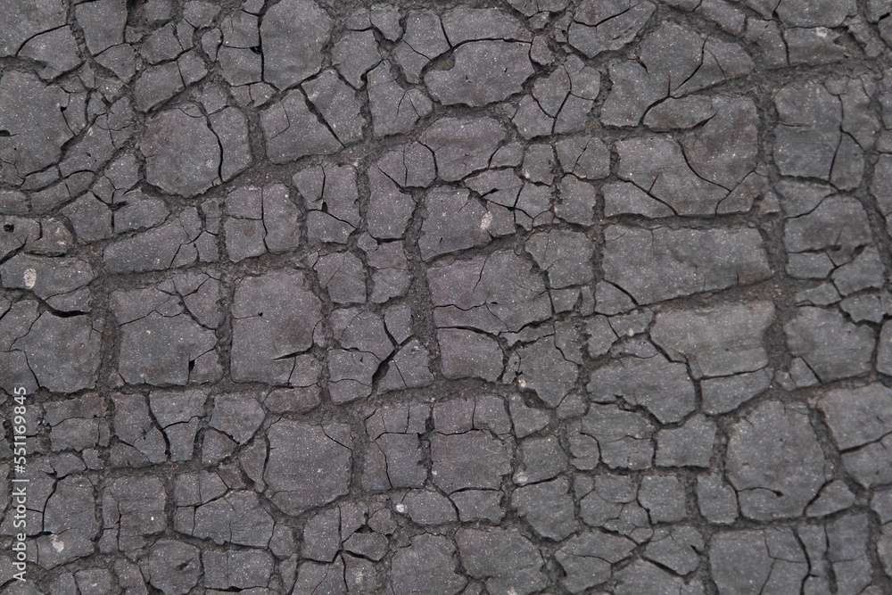 Weathered old dark gray ruberoid texture with numerous cracks and ...