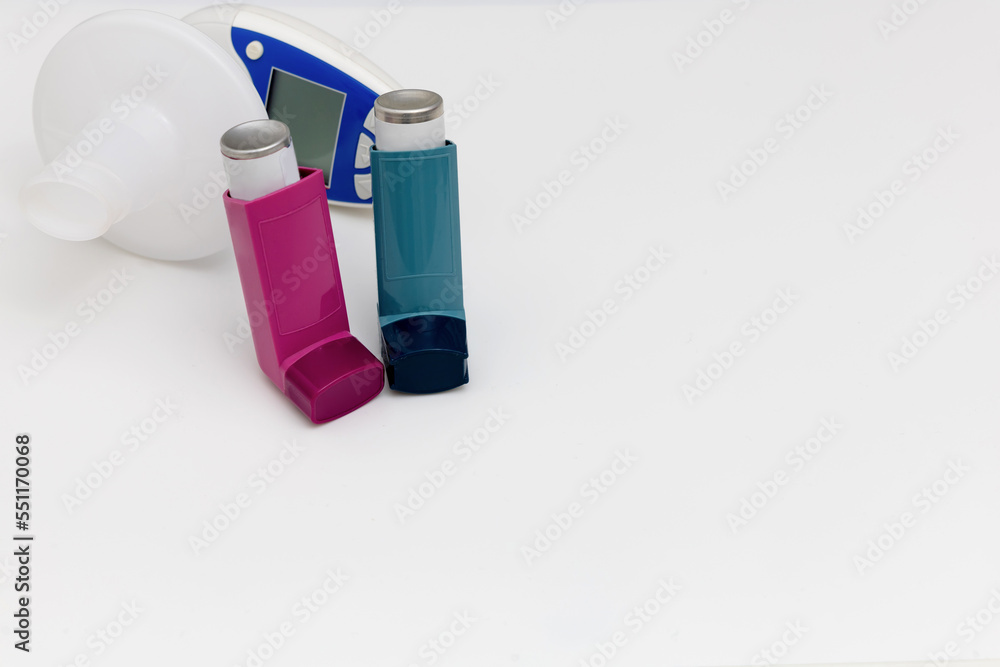 Asthma medications inhalers and peak flow meter on a white background ...