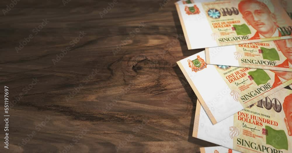 Singapore Dollar 100 SGD banknotes on the wooden table. Singapore ...