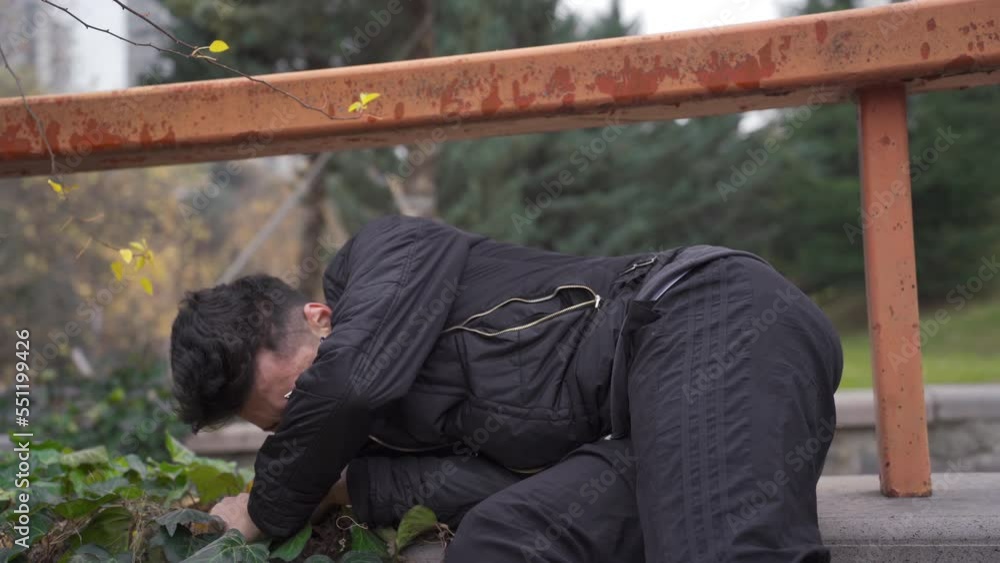 The depressed man sitting on the stairs outside is crying. Loneliness ...