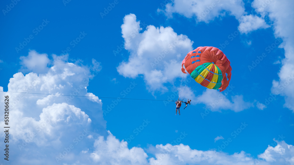 Parachute in the sky at the beach of Kata Phuket. bright blue sky with ...