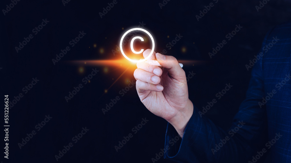 Businessman touching Copyright icon, patents and intellectual property ...