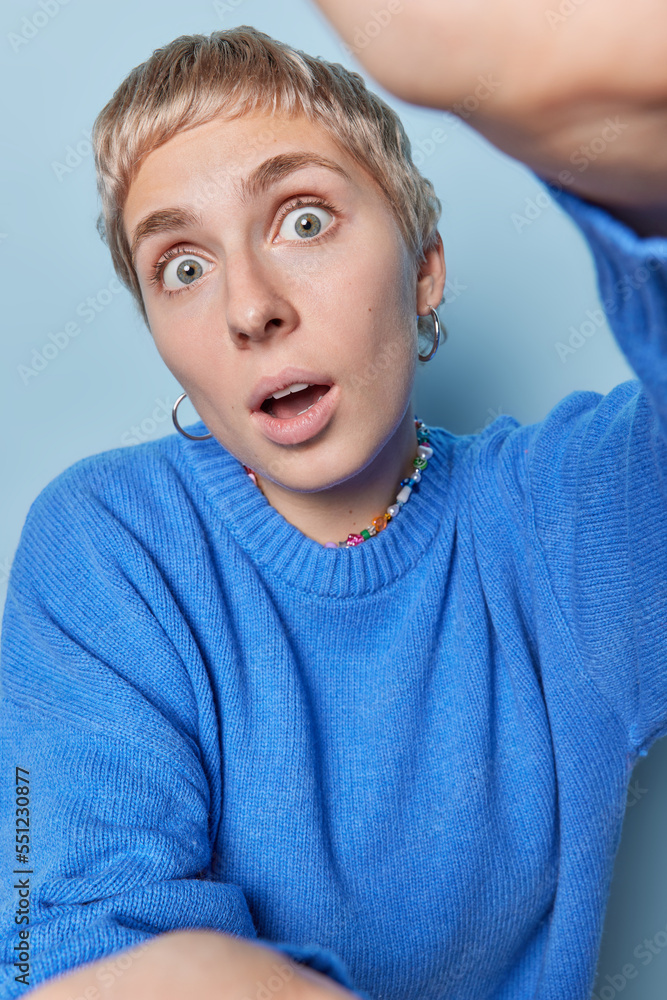 Astonished green eyed young woman stares impressed keeps mouth opened ...
