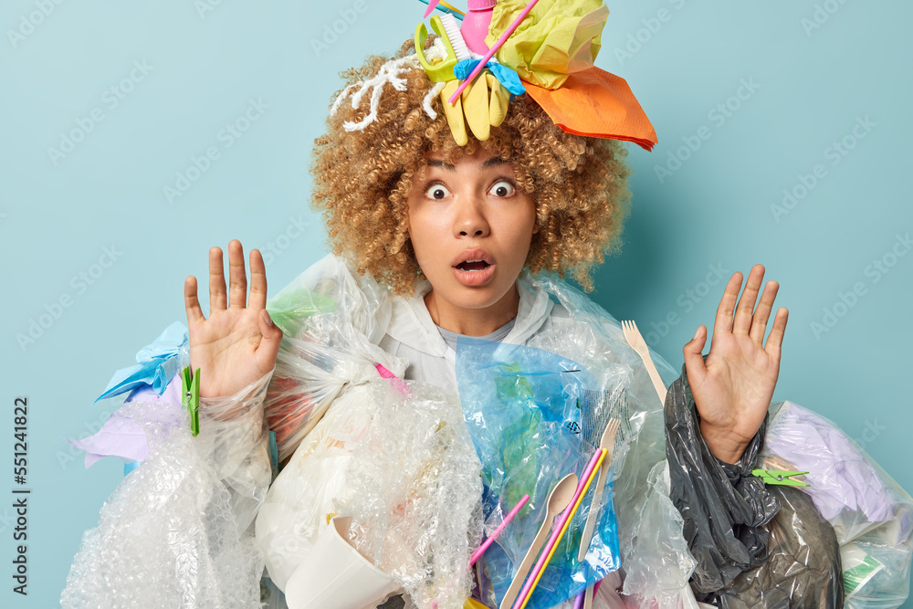 Stunned emotional female activist keeps palms raised and stares shocked ...