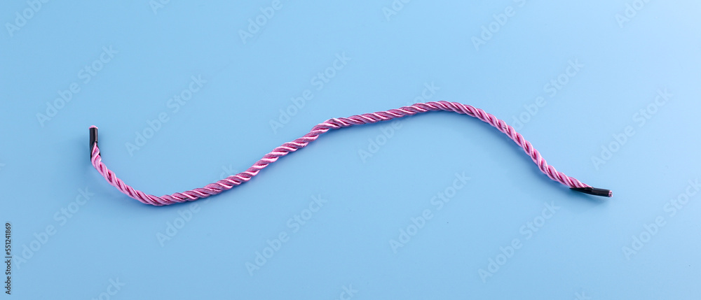 Blue background picture with a pastel pink rope Stock Photo | Adobe Stock