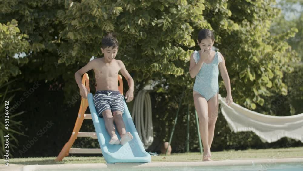 Children diving into swimming pool in slow motion. Asian boy rolling ...