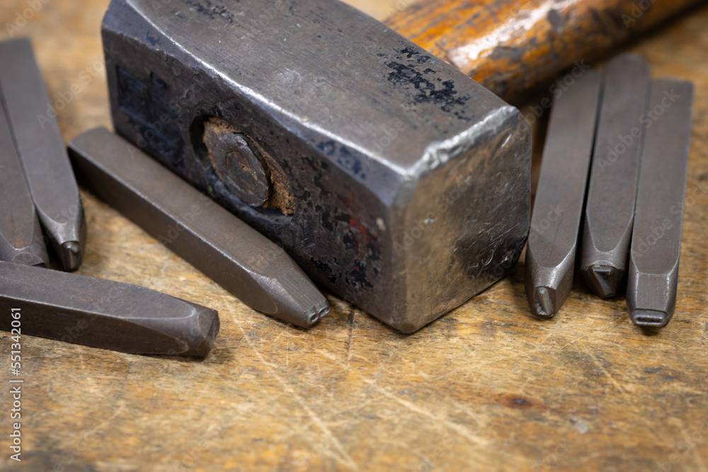 hammer and punch numbers on an old workbench Stock Photo | Adobe Stock