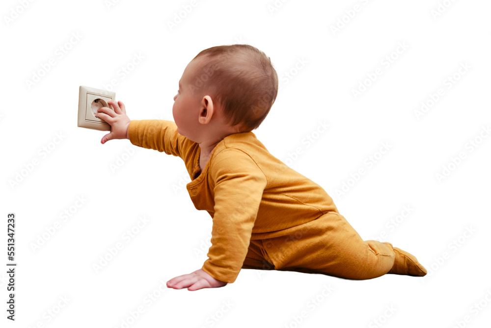 Baby toddler reaches into the electrical outlet on the home wall with ...