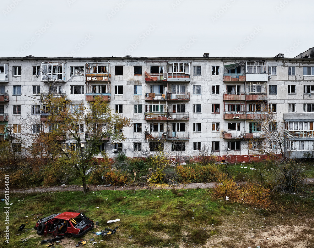 Yard of destroyed apartment buildings in the war zone. Damage to a ...