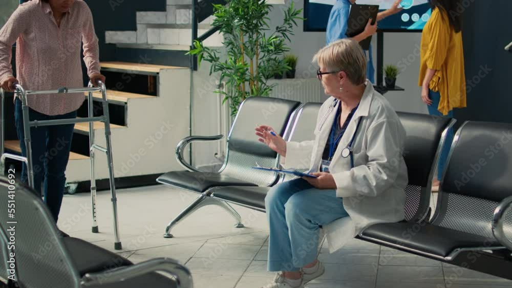 Asian patient with leg injury walking with walk frame and doing ...