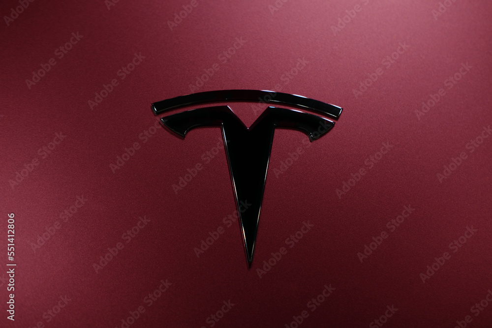 Closeup chromium-plated Logotype Tesla Motors on red hood, most popular ...