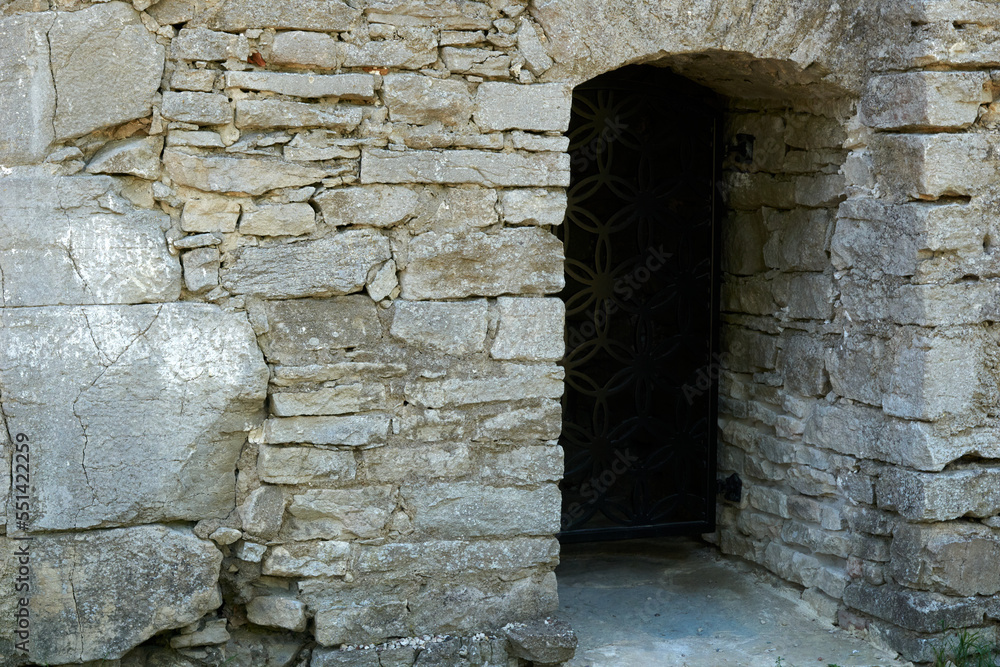 Arch in an old stone wall. Ruins of the old castle. The wall from the ...